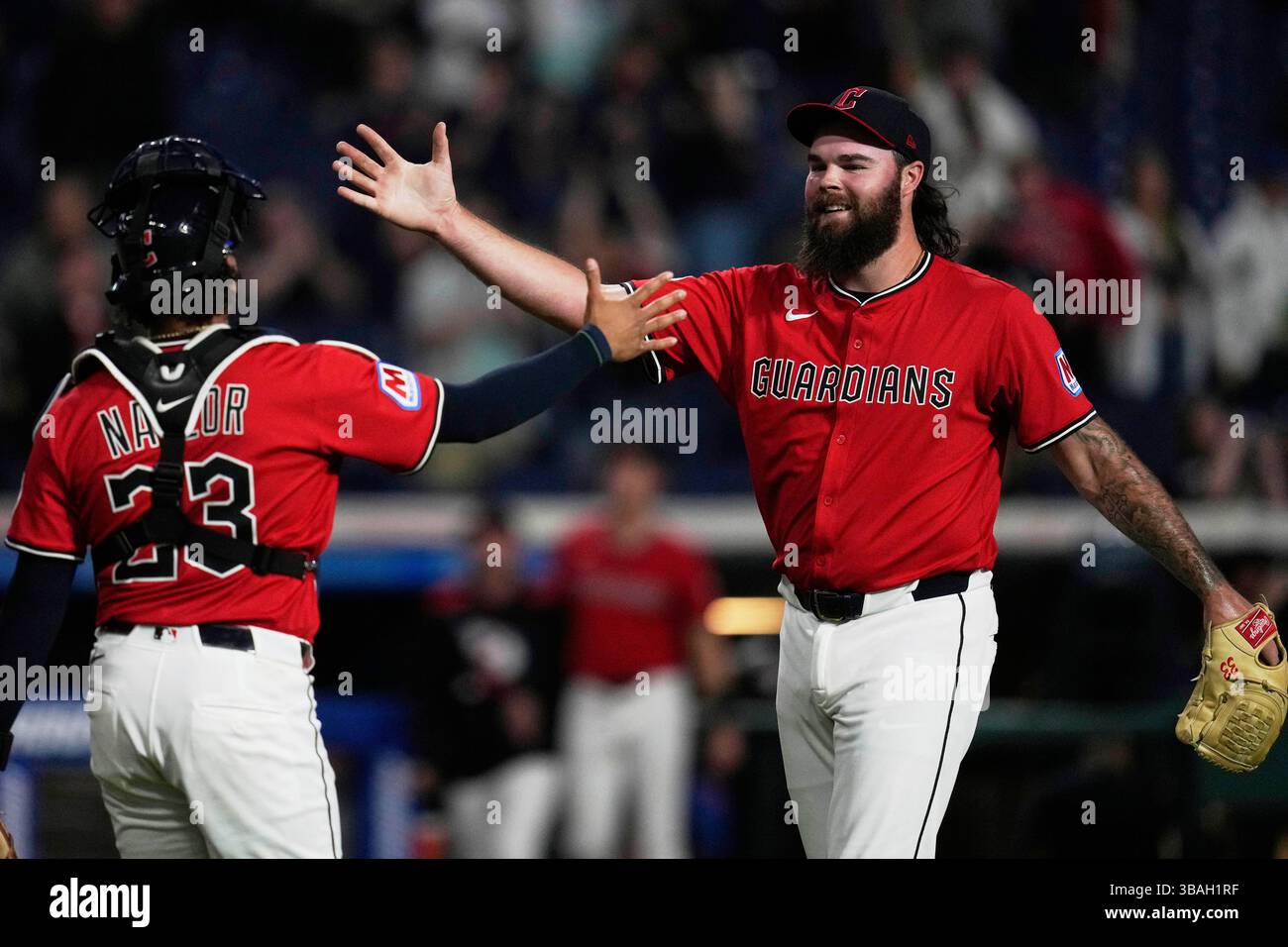 Cleveland Guardians catcher Bo Naylor (23) congratulates relief pitcher ...