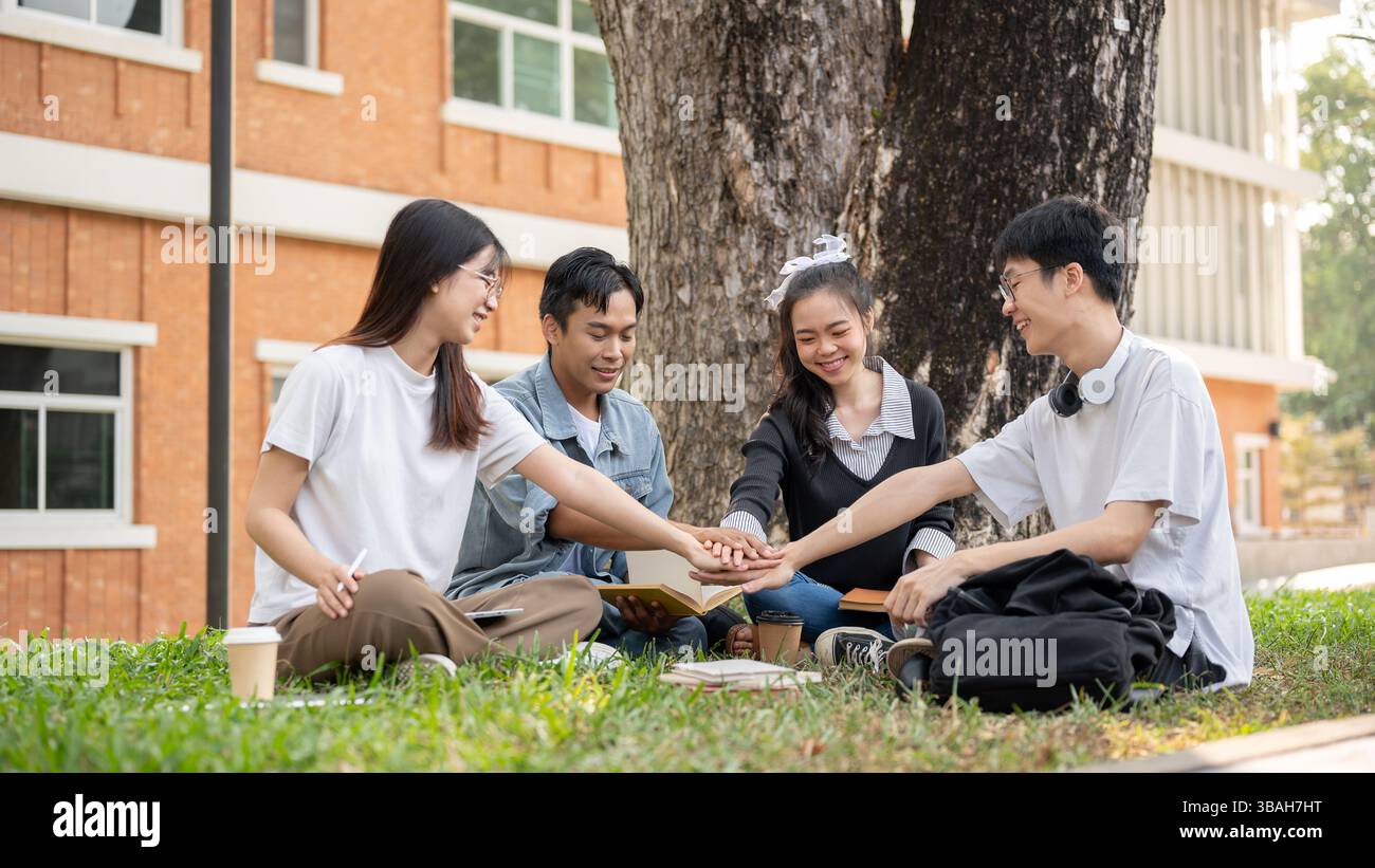 A group of teamwork and positive young Asian college students are ...
