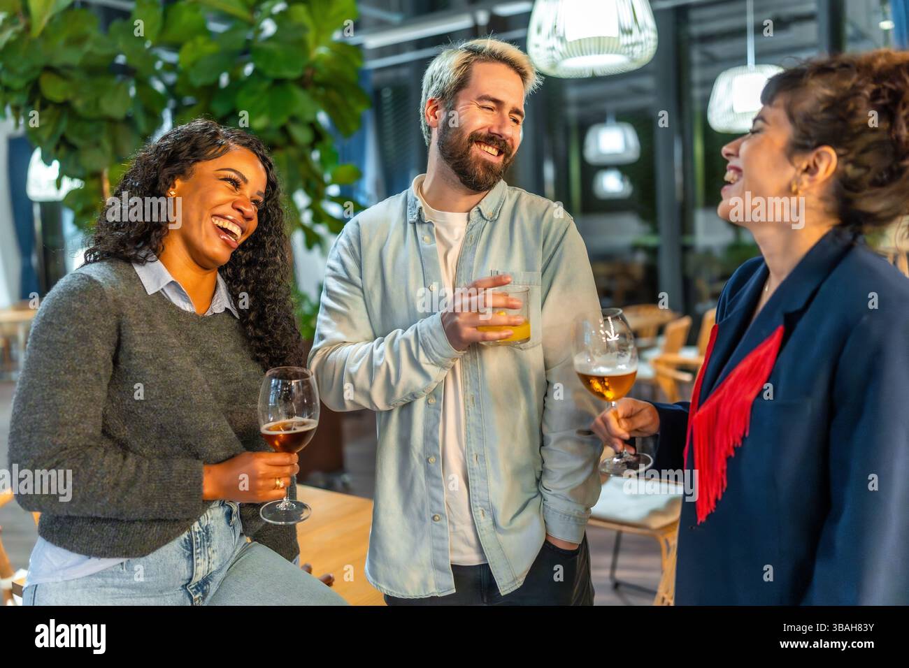 Diverse group of friends having fun drinking alcohol and having ...