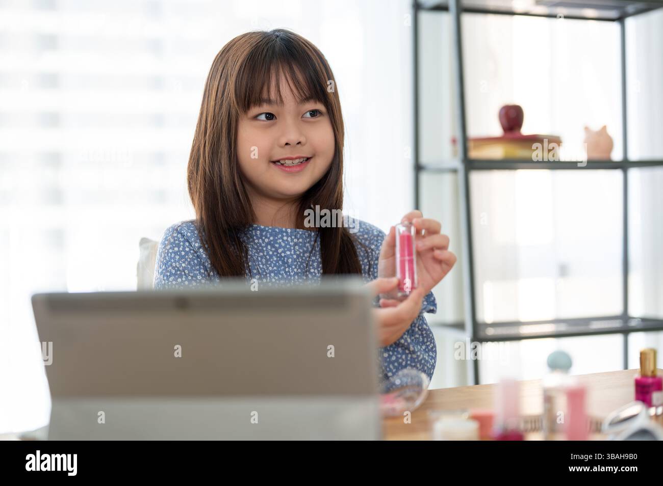 A talented and cute young Asian girl is reviewing her kid cosmetic on ...