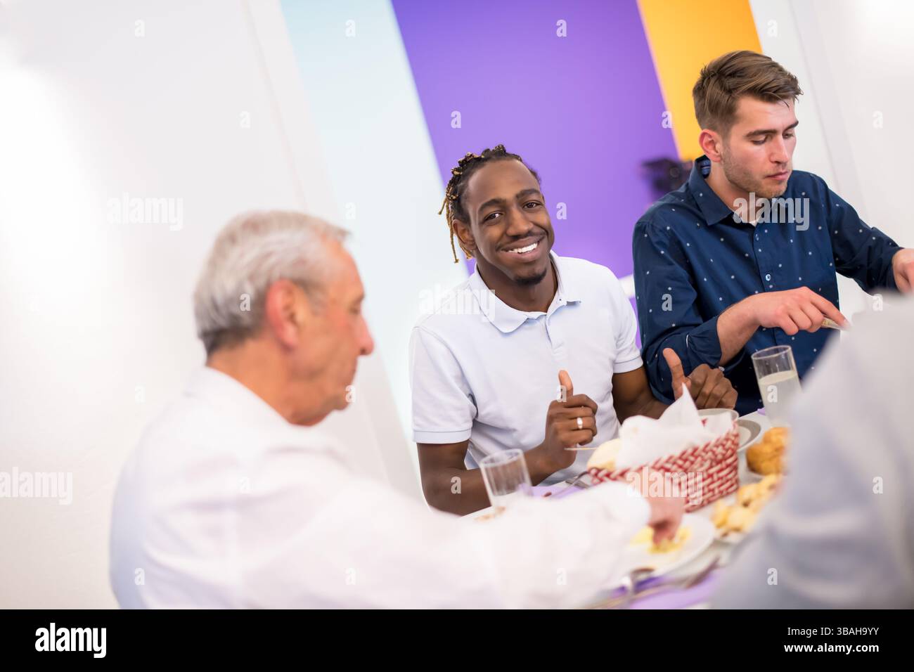 african american man enjoying iftar dinner together with modern ...