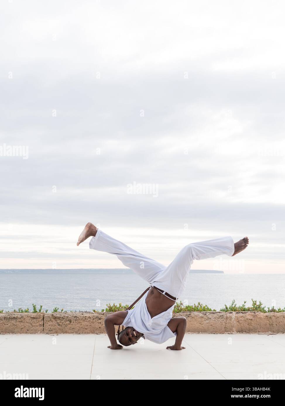 Brazilian male capoeira martial artist wearing white shirt and pants ...