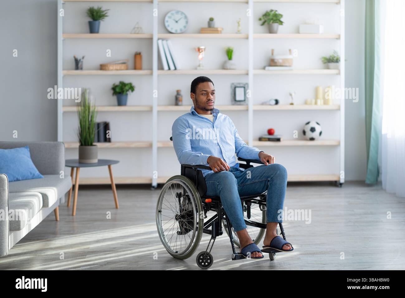 Full length of impaired African American guy suffering from disability ...