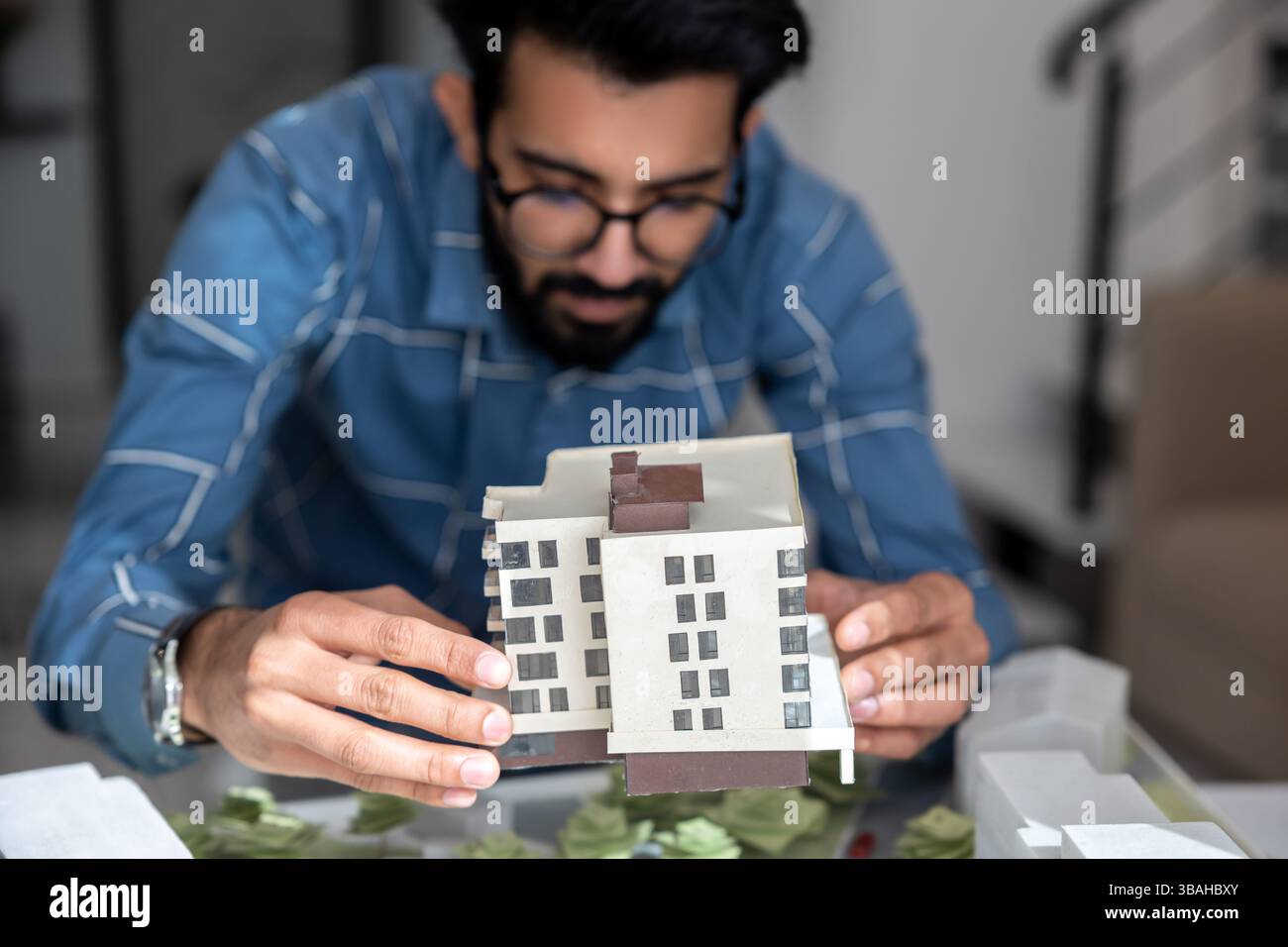 House mock up. Young engineer looking busy and involved while preparing ...