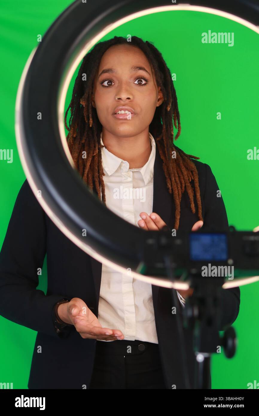 Black woman of Afro-Caribbean descent with dreadlocks dressed in formal business attire set ...