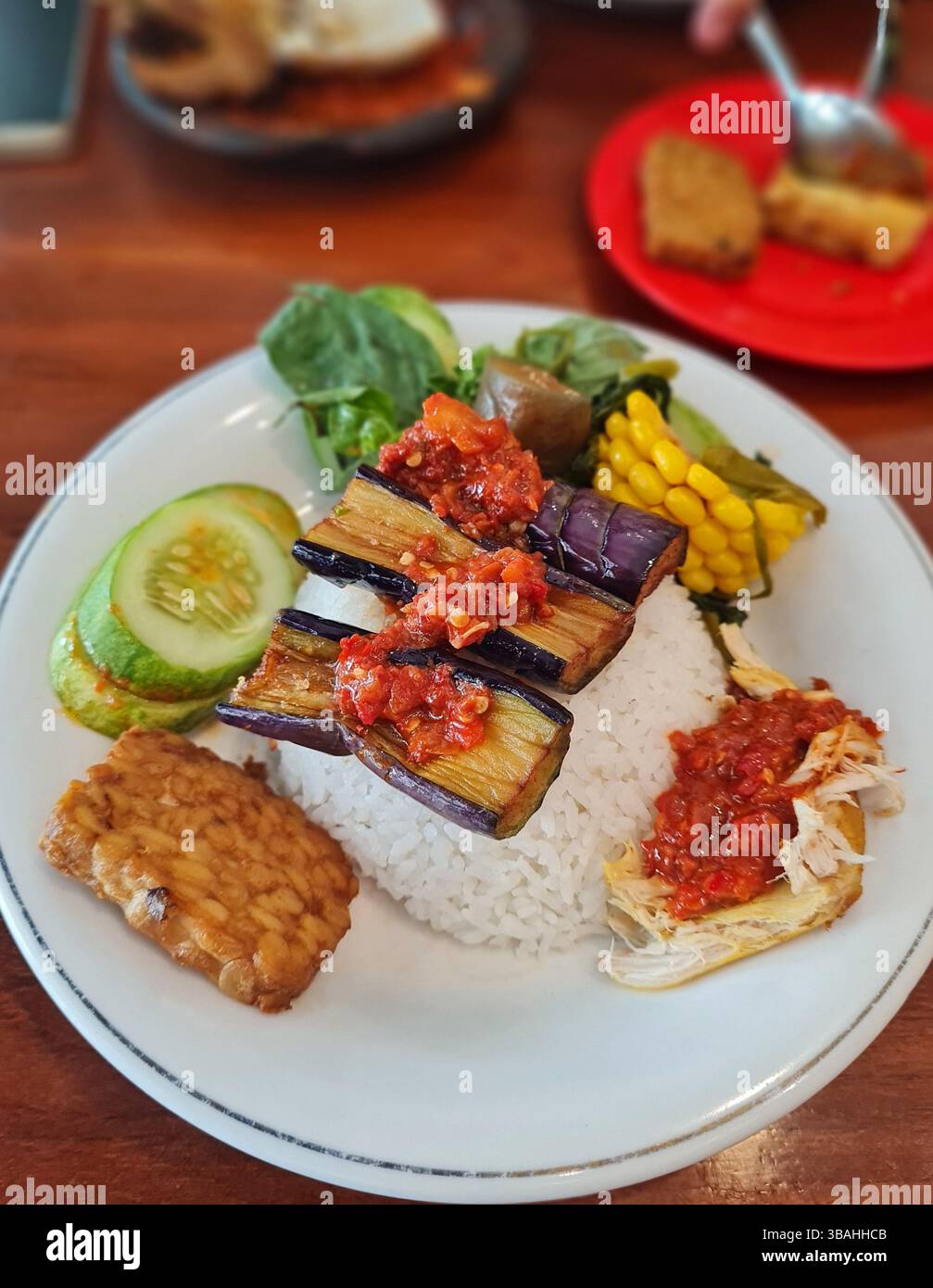 A Sundanese Indonesia meal of plain rice with fried chicken, fried ...