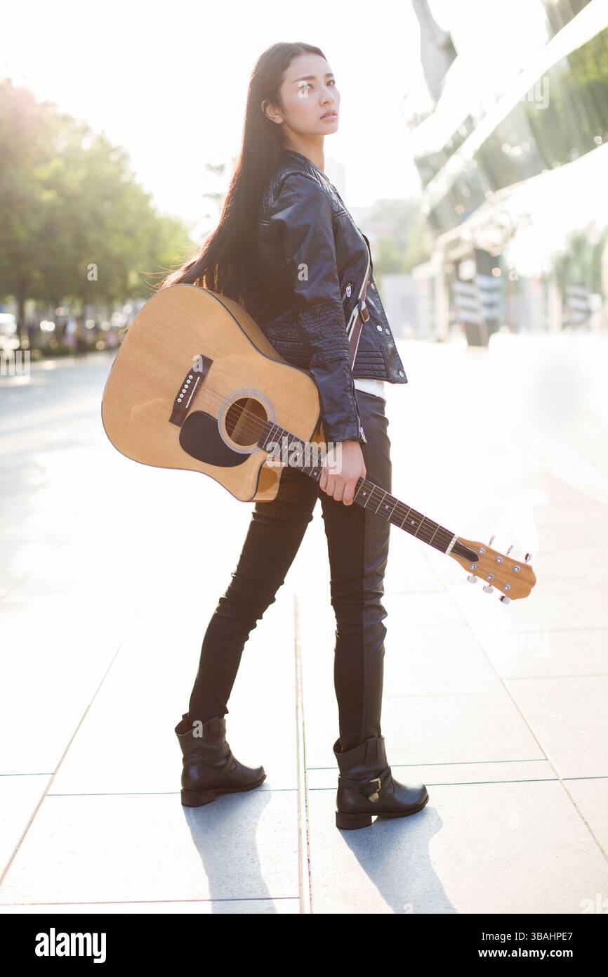 Chinese female guitarist Stock Photo - Alamy