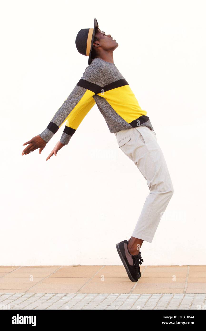 Full length side portrait of african male dancer standing on his tip ...