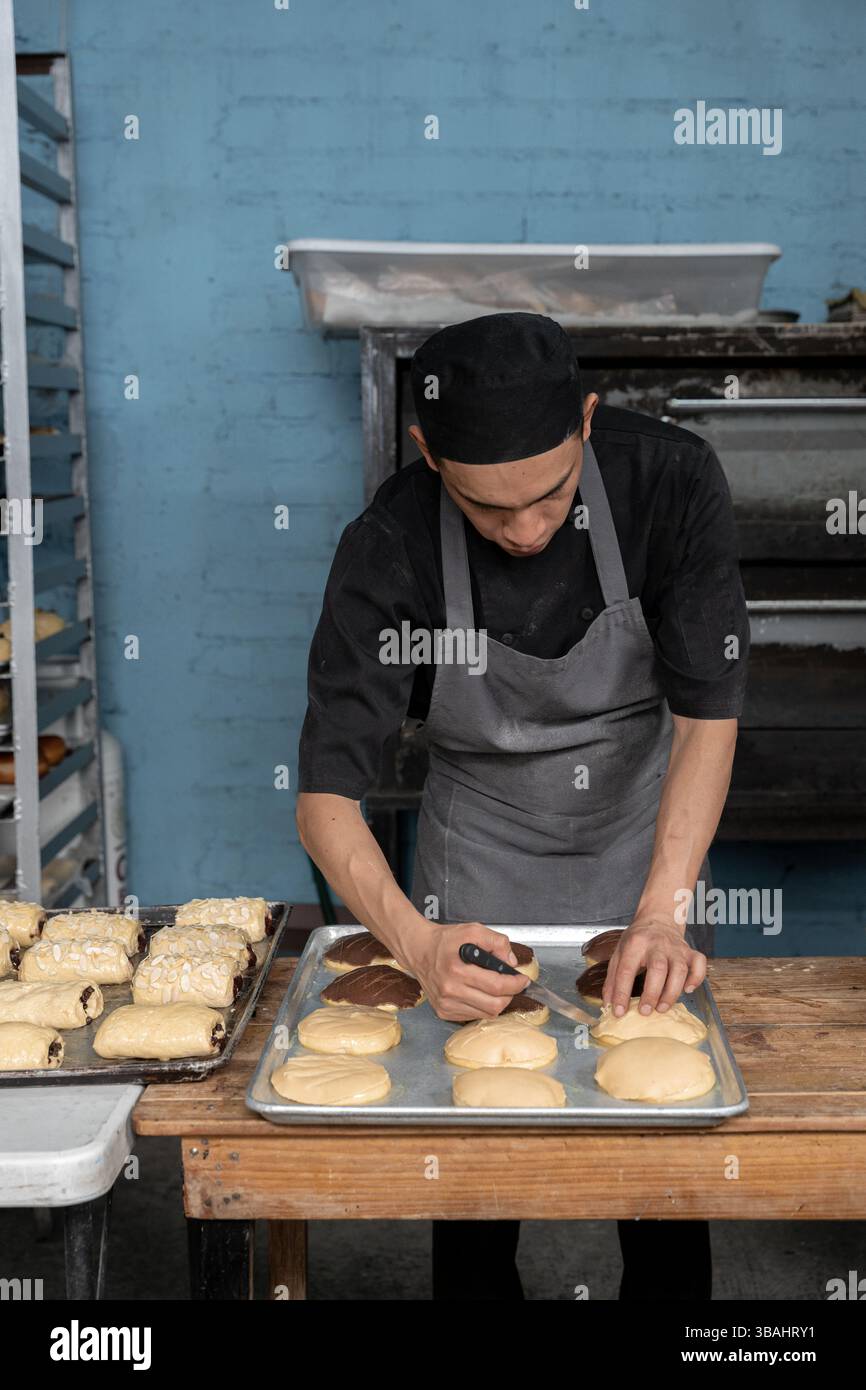 Hispanic baker is doing marks to make Mexican chocolate shells ...