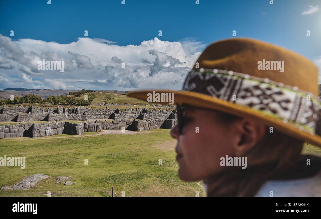 Hispanic female tourist wearing hat and sunglasses standing and ...