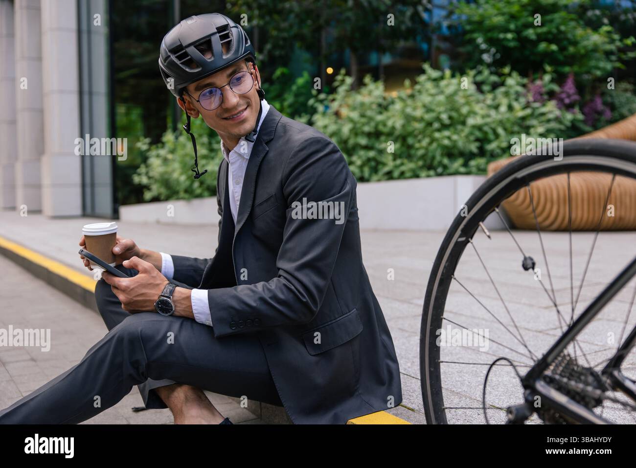 Coffee before work. Man having coffee after commuting to the office by ...