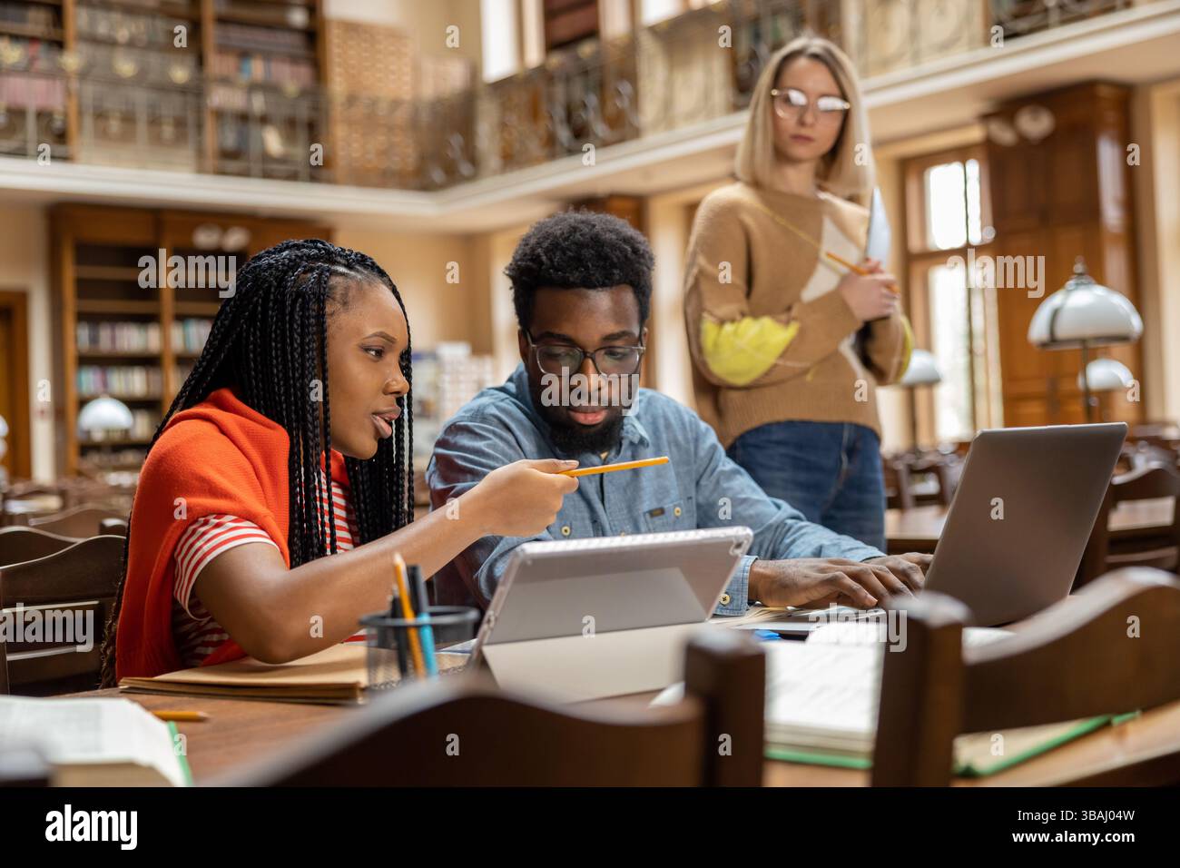 Team work. Team of students looking involved and interested while ...