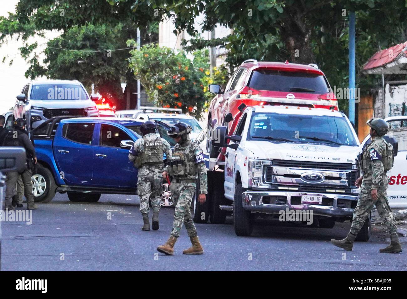 Navy officers stand guard near a vehicle involved in a shootout in ...