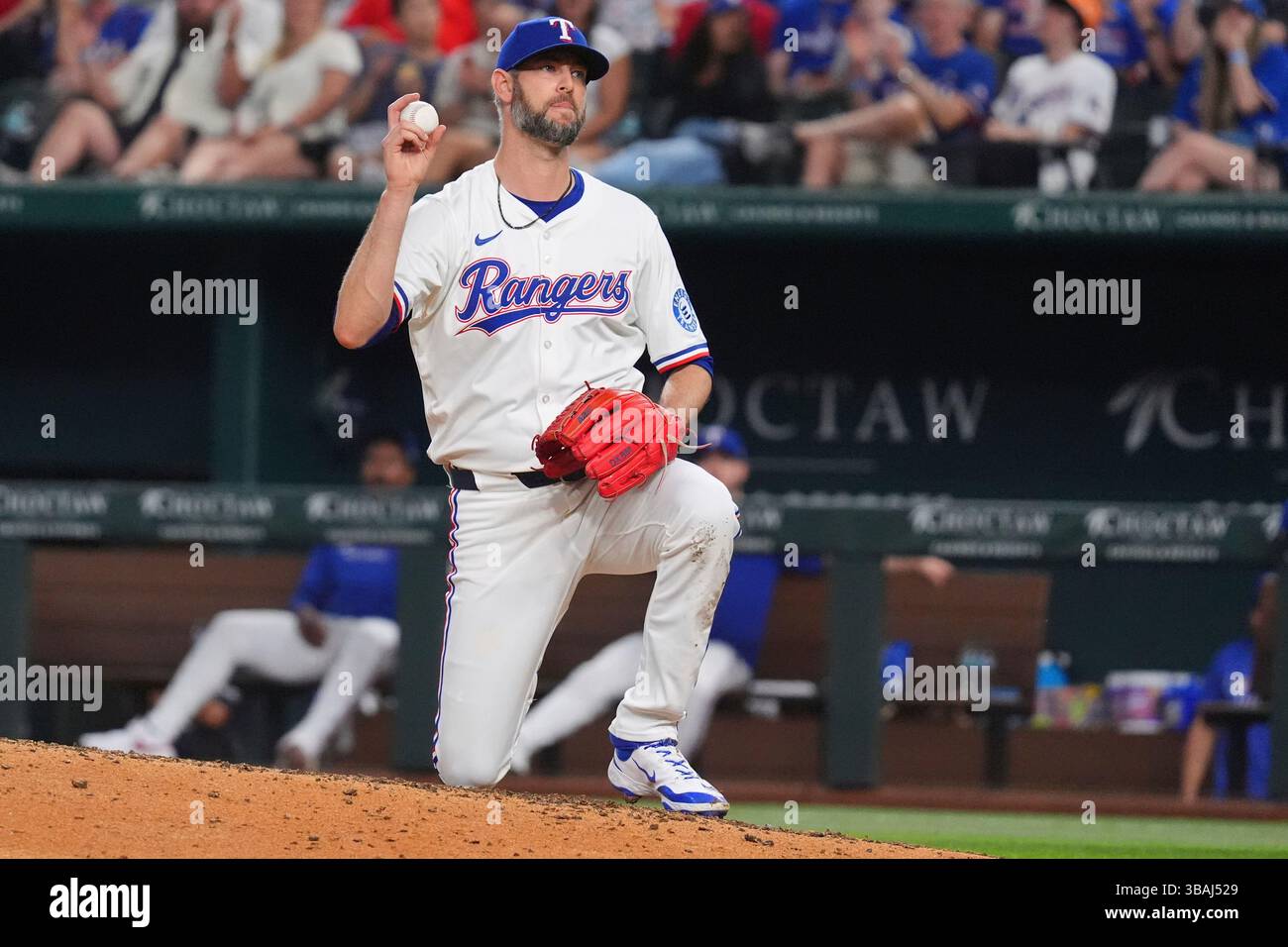 Texas Rangers' pitcher Chris Martin holds up the ball after catching a ...