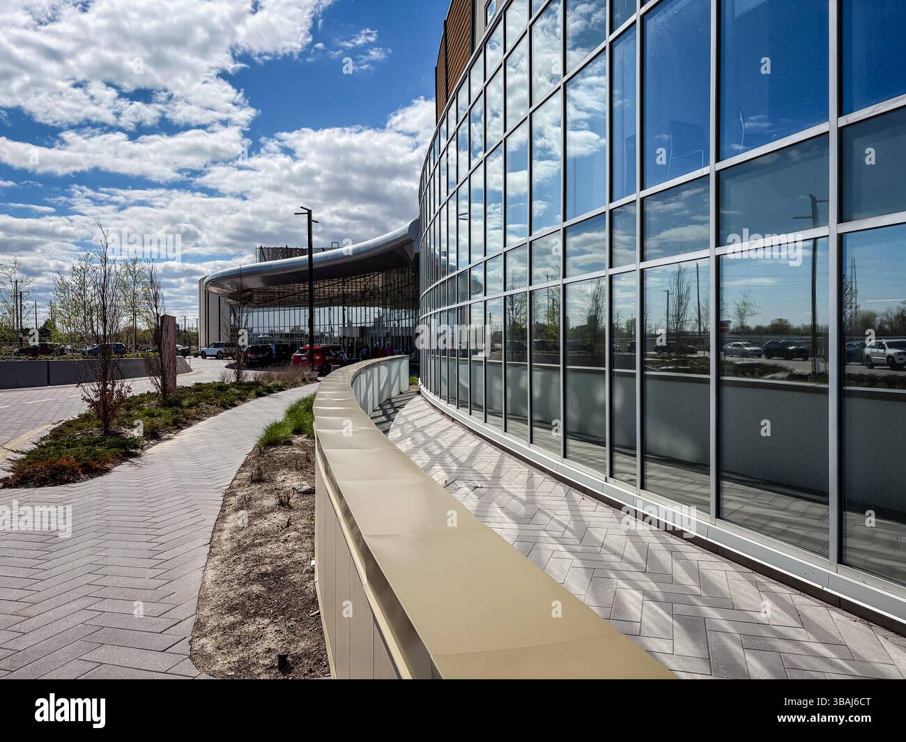 Exterior view of a modern convention center with curved glass facade ...