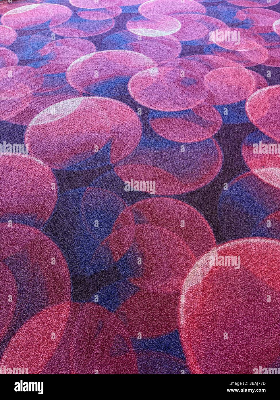 Abstract carpet pattern with overlapping pink and purple circles on ...