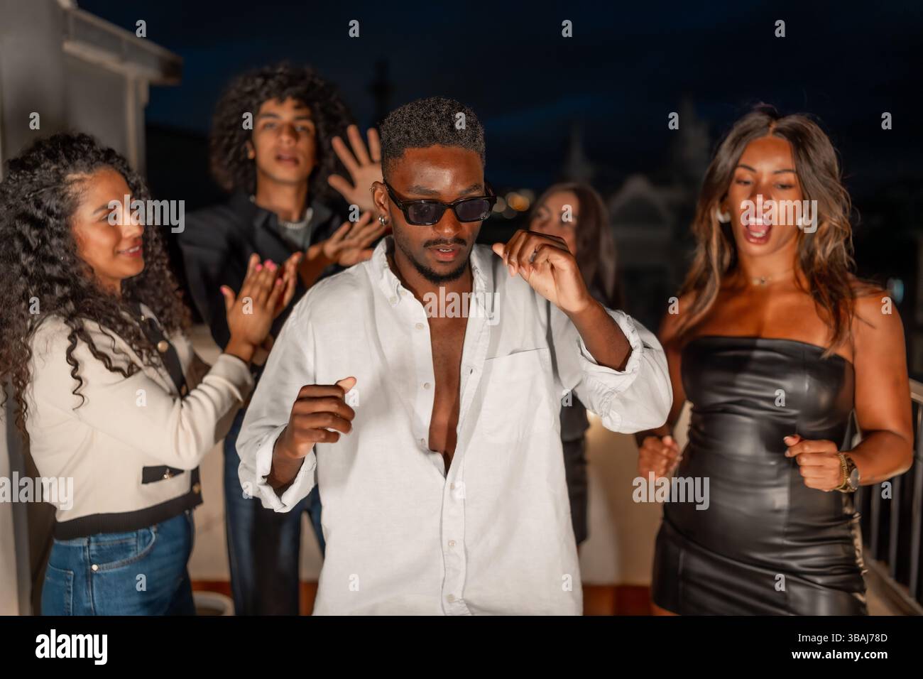 Black man wearing sunglasses and white shirt dancing with friends ...