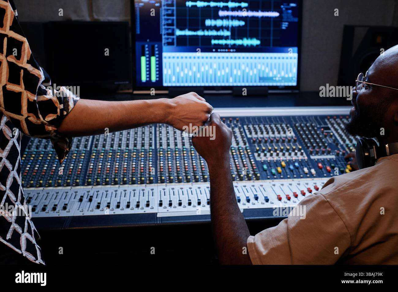 Professional music producer and young singer finishing work on album in ...