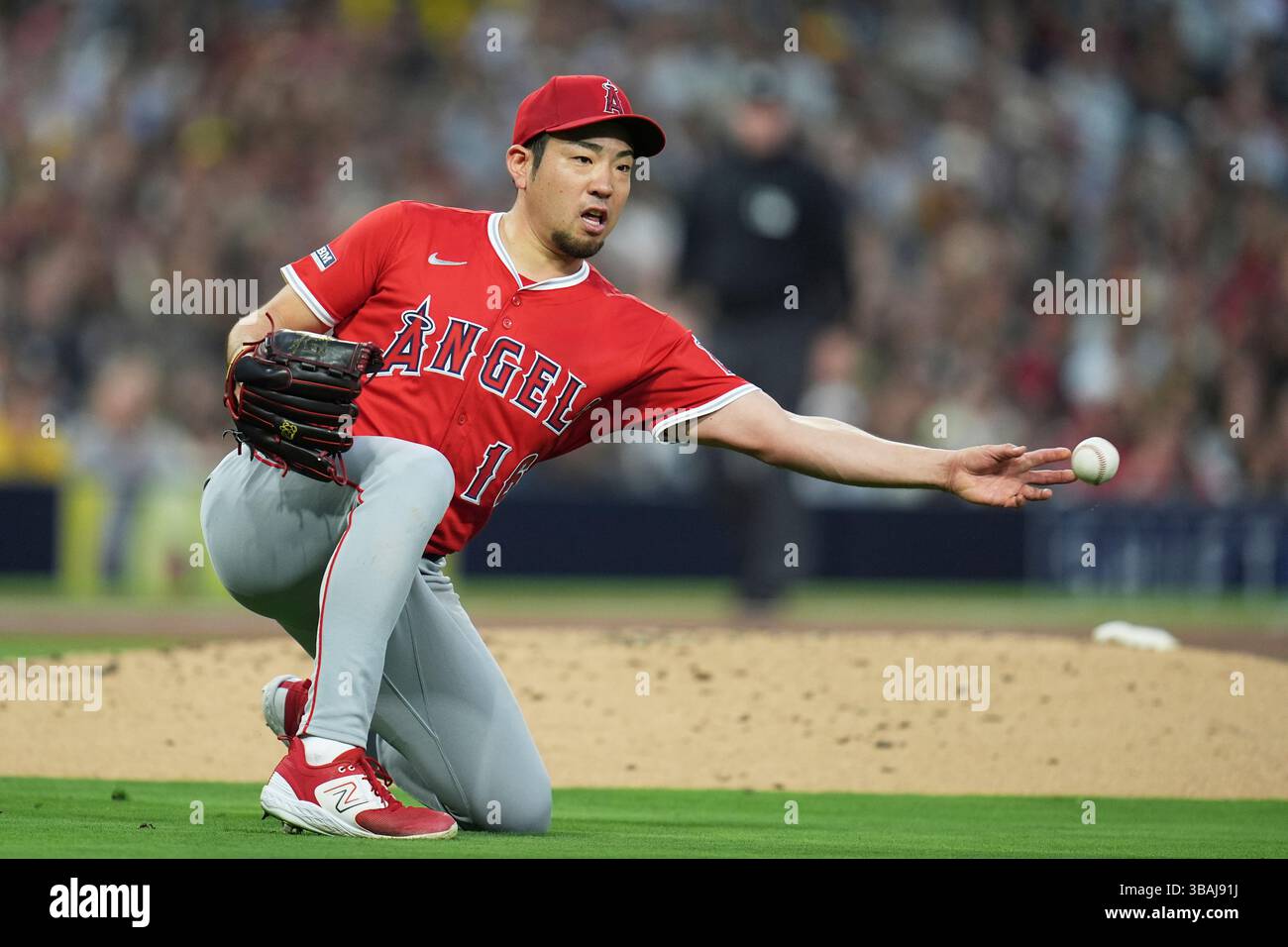 Los Angeles Angels starting pitcher Yusei Kikuchi overthrows first base ...