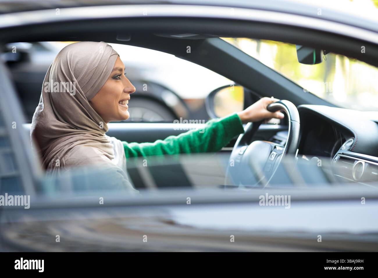 Female Driver. Side view profile portrait of positive islamic lady ...