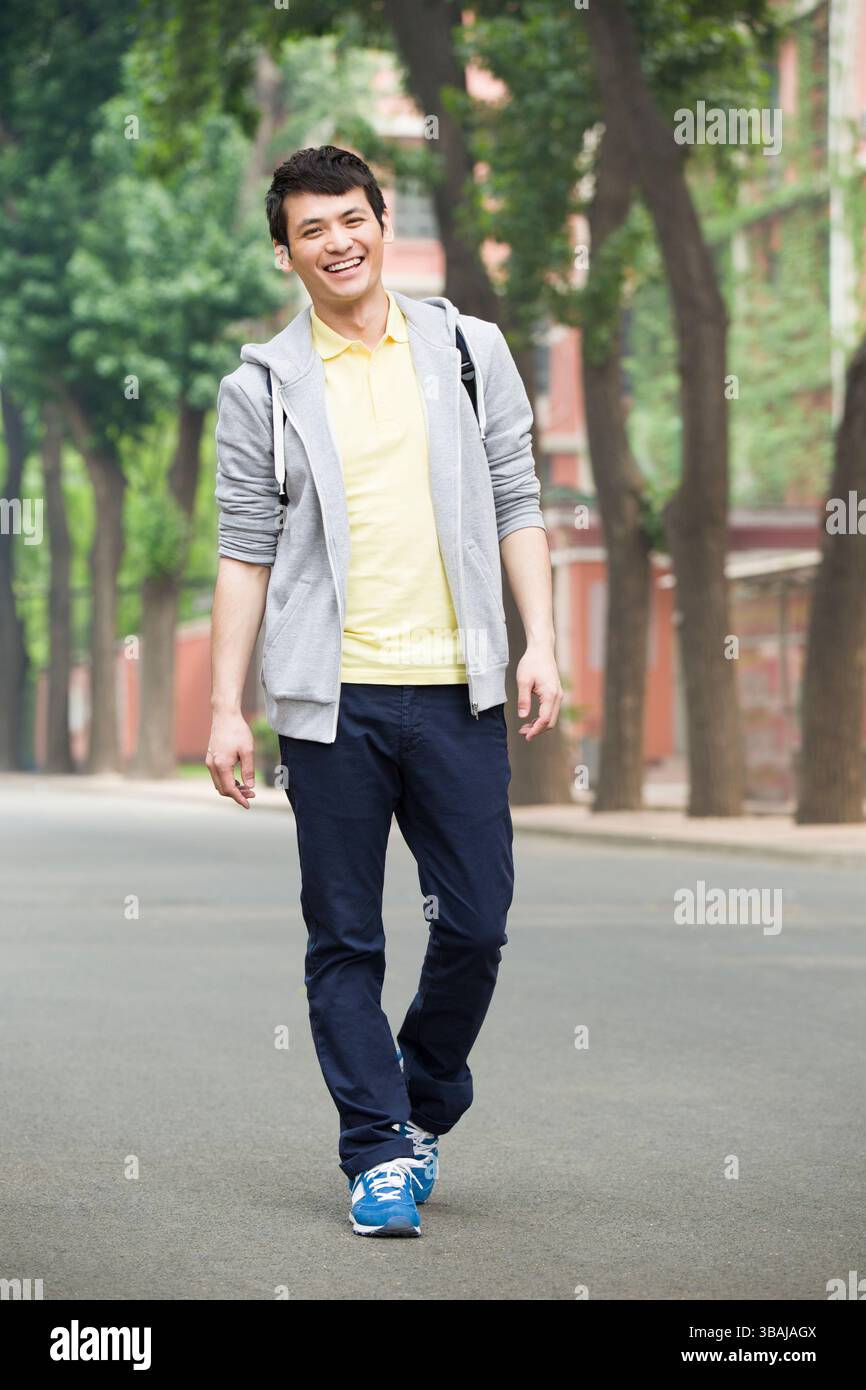 Male Chinese college student walking on campus Stock Photo - Alamy