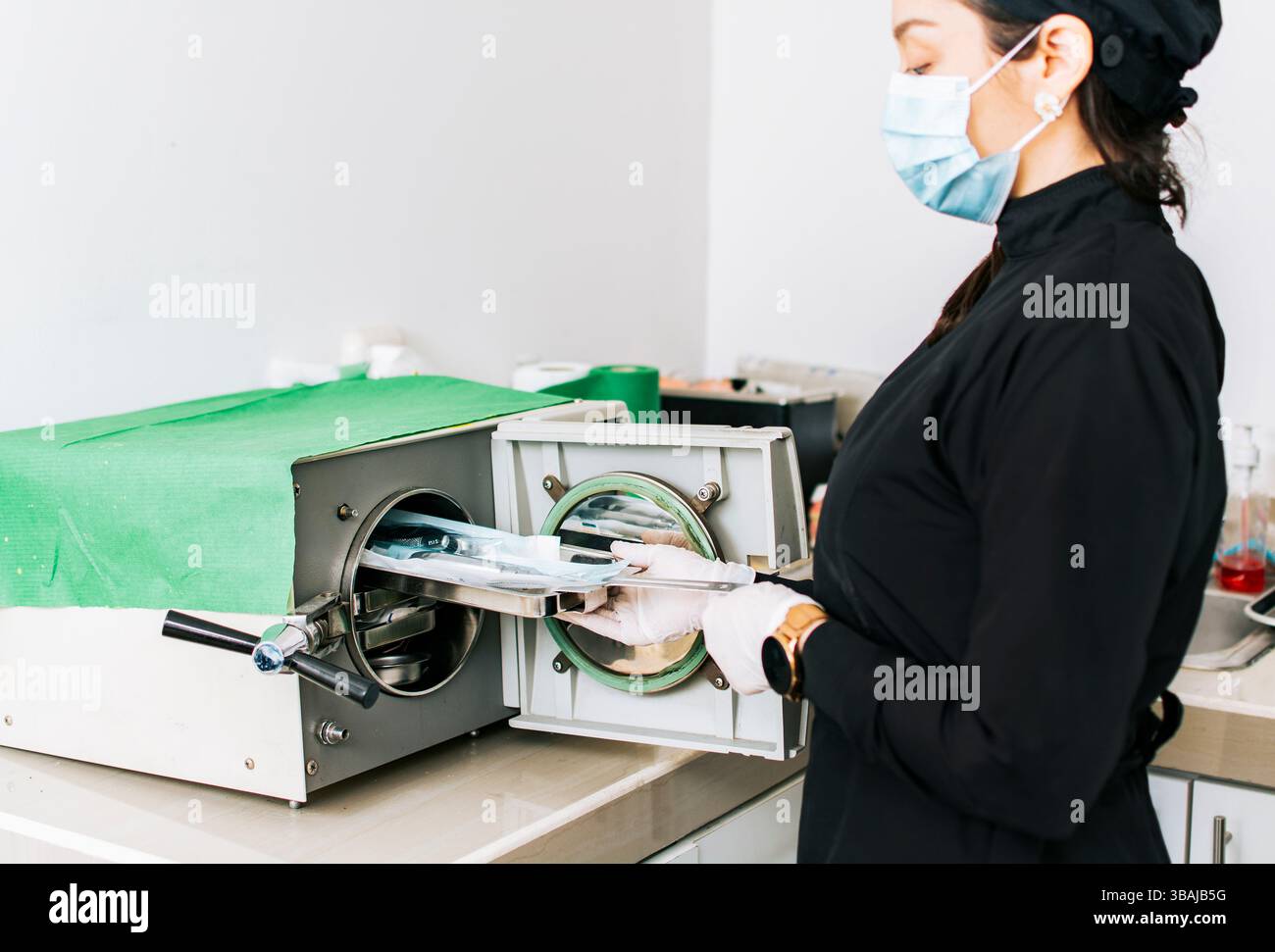 Nicaraguan female dentist wearing gloves and face mask standing at ...