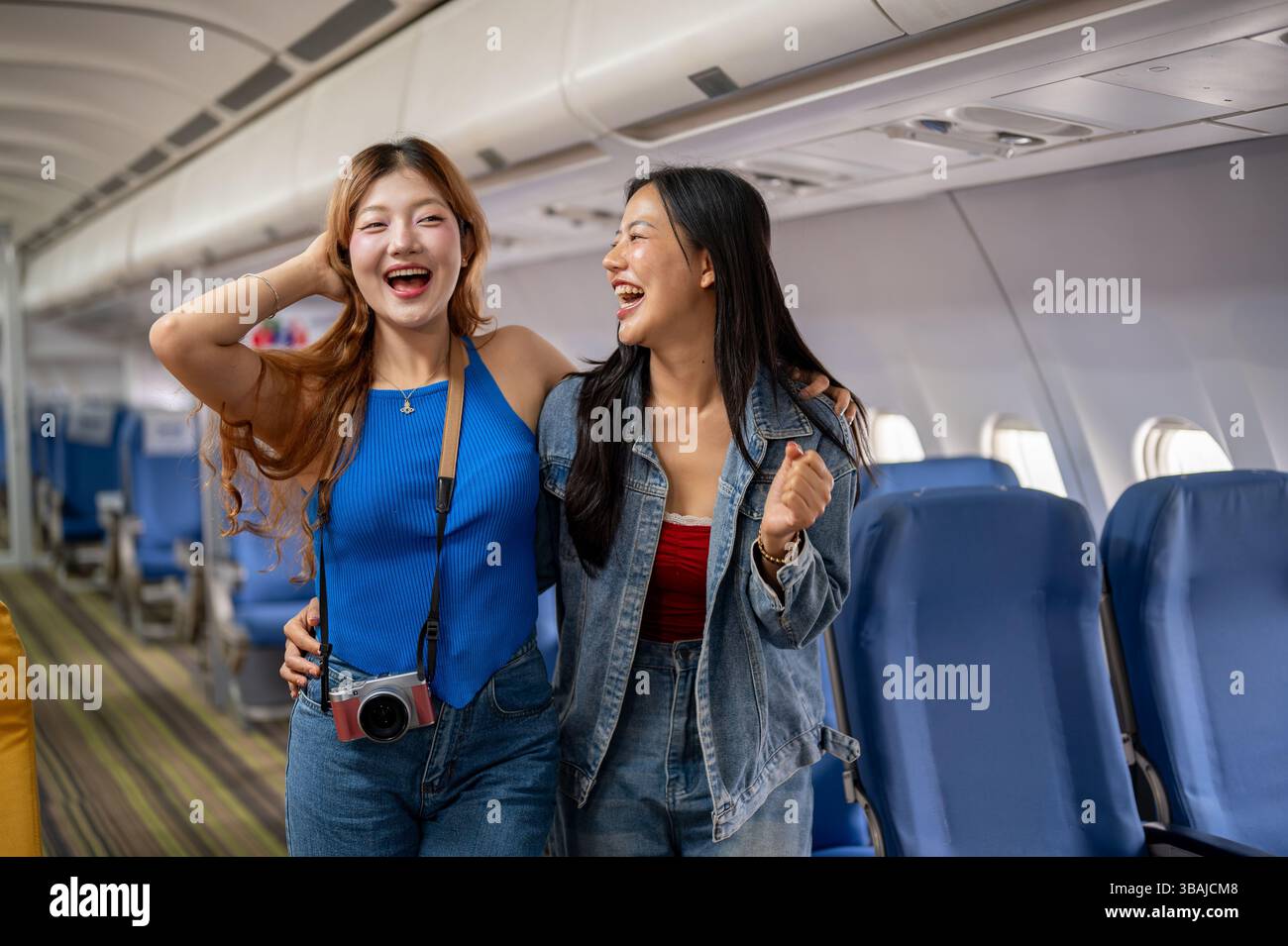 Two joyful, attractive Asian female friends, excited for their summer ...