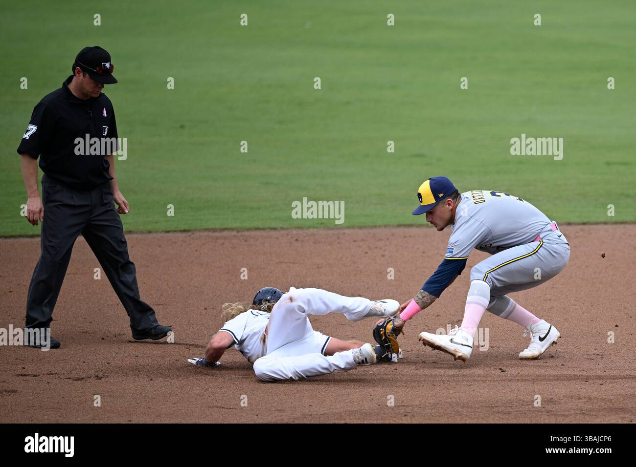 Umpire D.J. Reyburn, left, looks on as Tampa Bay Rays' Travis Jankowski ...