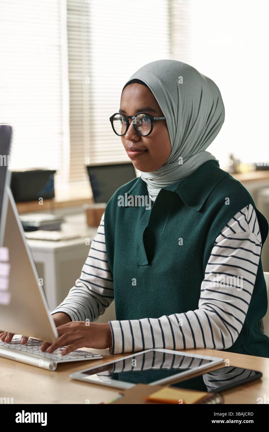 Young serious Muslim woman in eyeglasses, hijab and casualwear ...