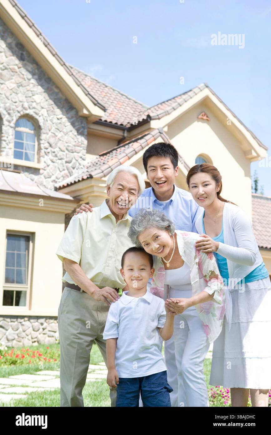 Chinese family in front of house Stock Photo - Alamy