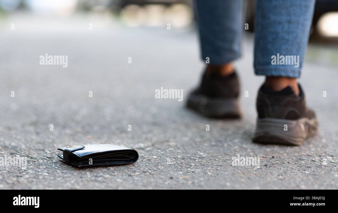 Money Loss Concept. Person has lost his wallet on city street, close up ...
