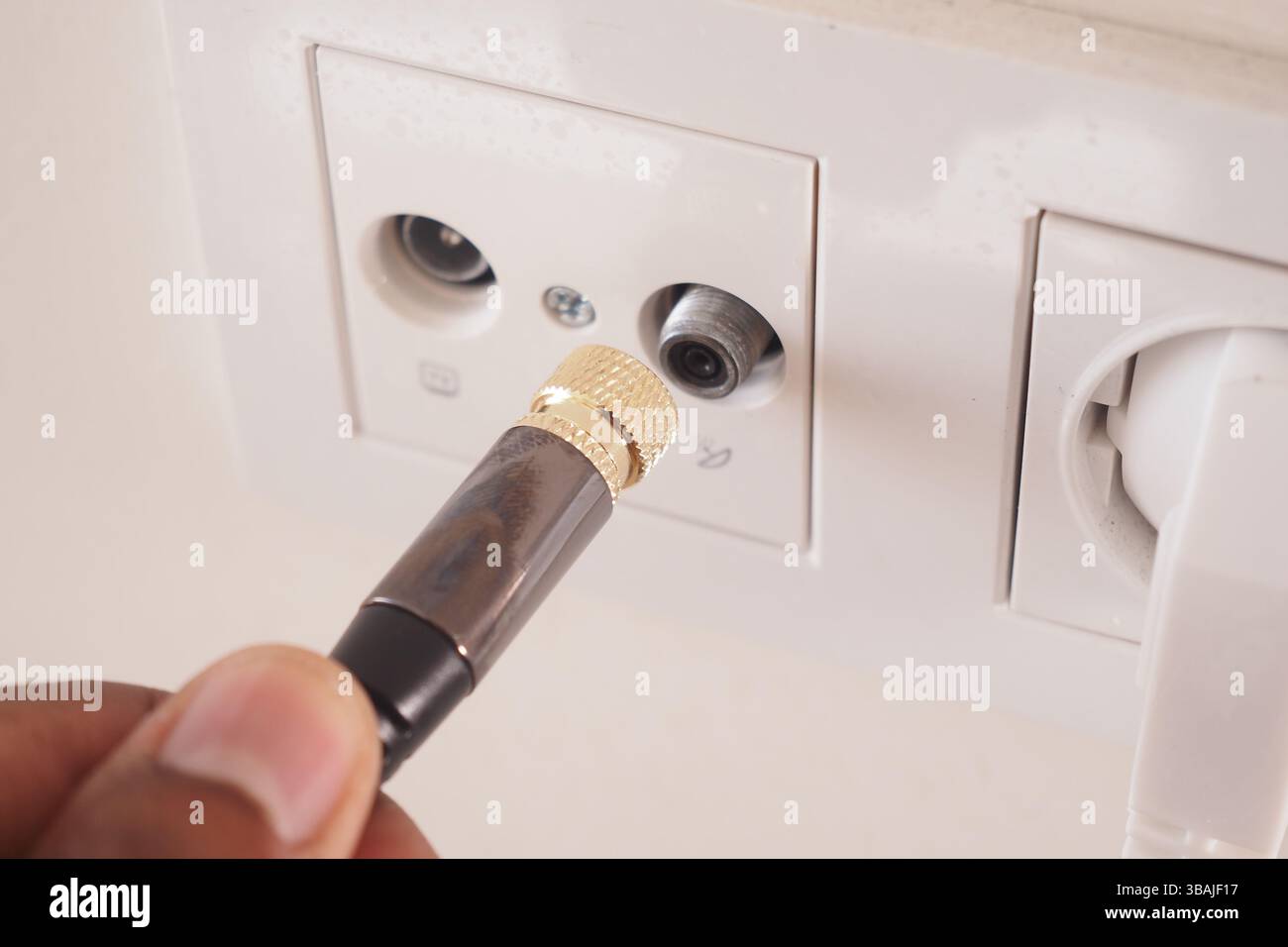 Connector being plugged into wall socket for electrical device Stock ...