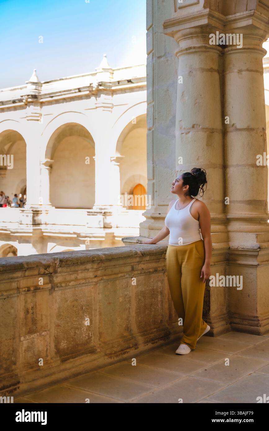Hispanic female tourist admiring historic architecture while standing ...