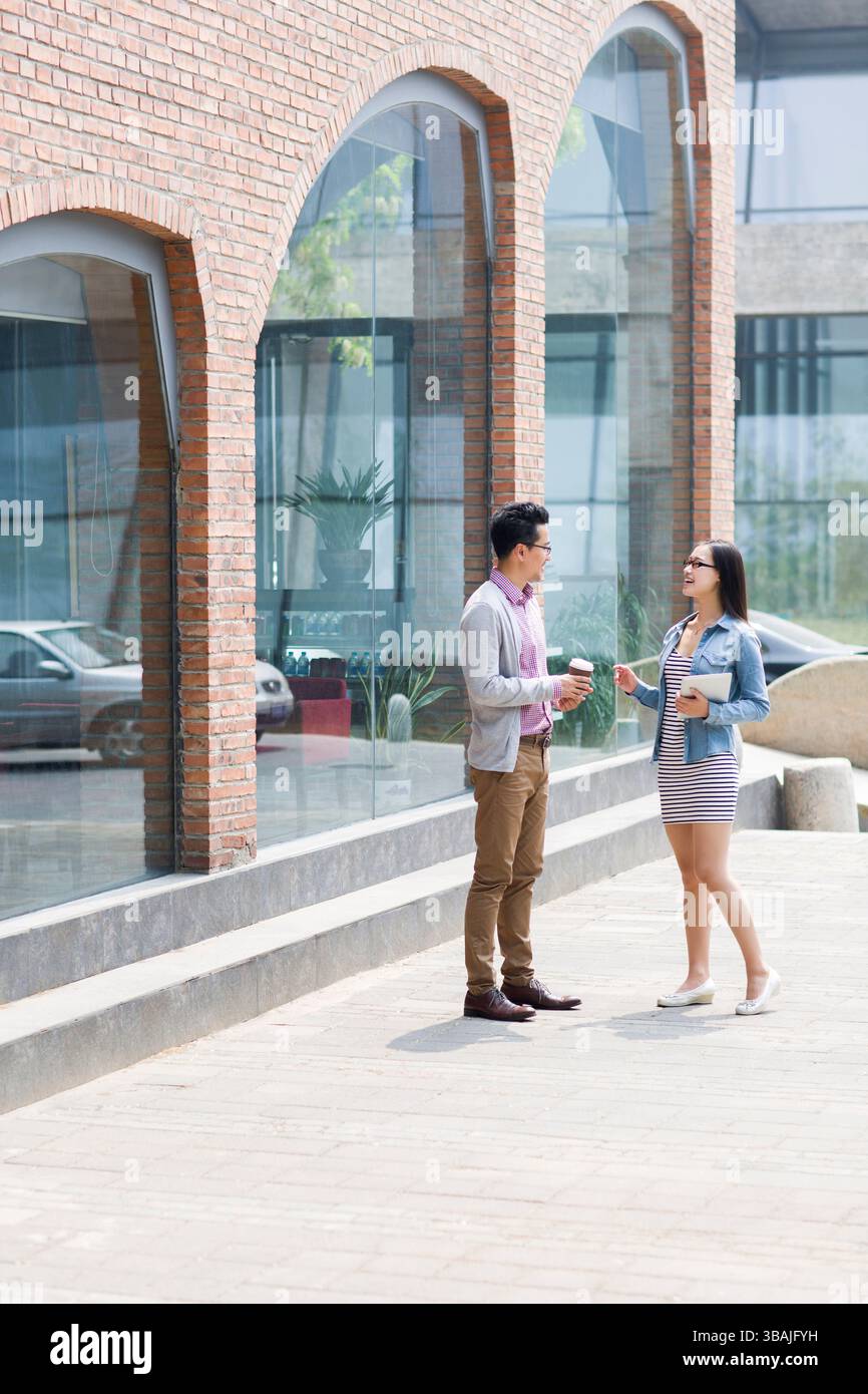 Chinese business partners in cultural industry talking Stock Photo - Alamy