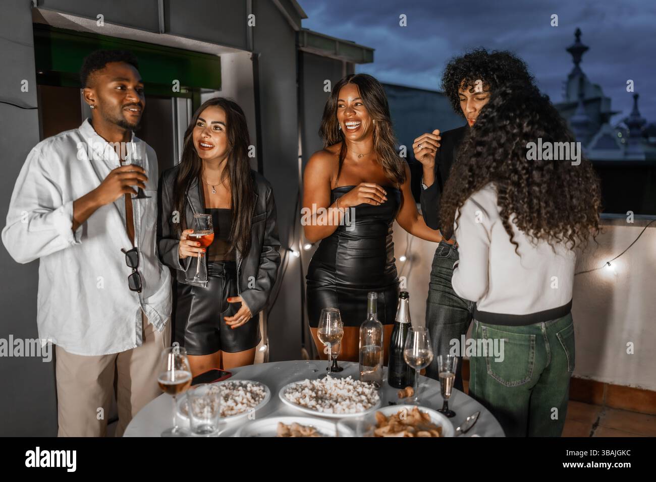 Diverse group of friends having fun drinking alcohol standing together ...