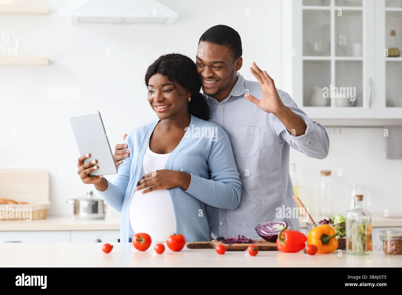 Positive expecting african american couple having video call with ...