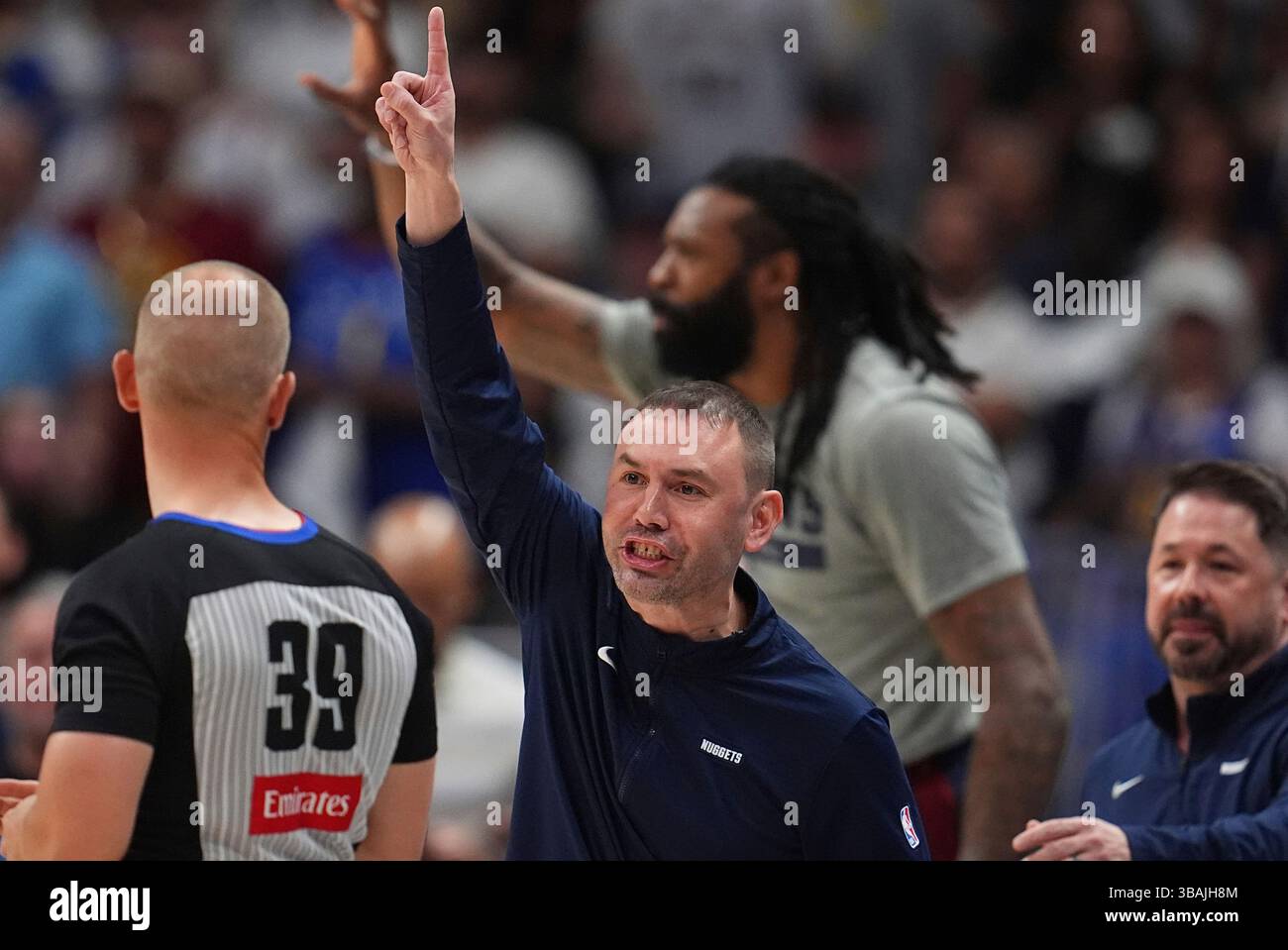 Denver Nuggets interim head coach David Adelman argues for a call with ...