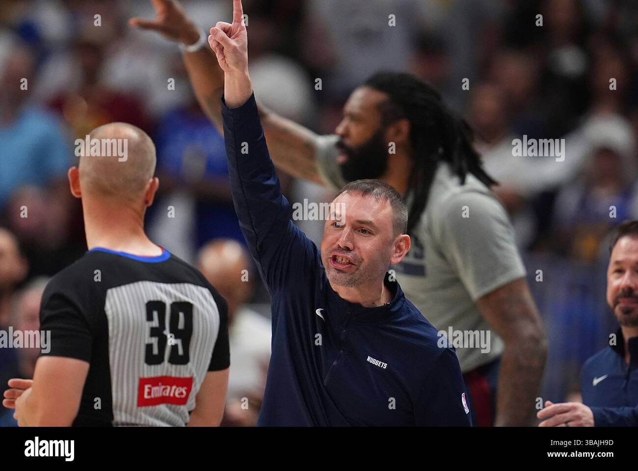 Denver Nuggets interim head coach David Adelman argues for a call with ...