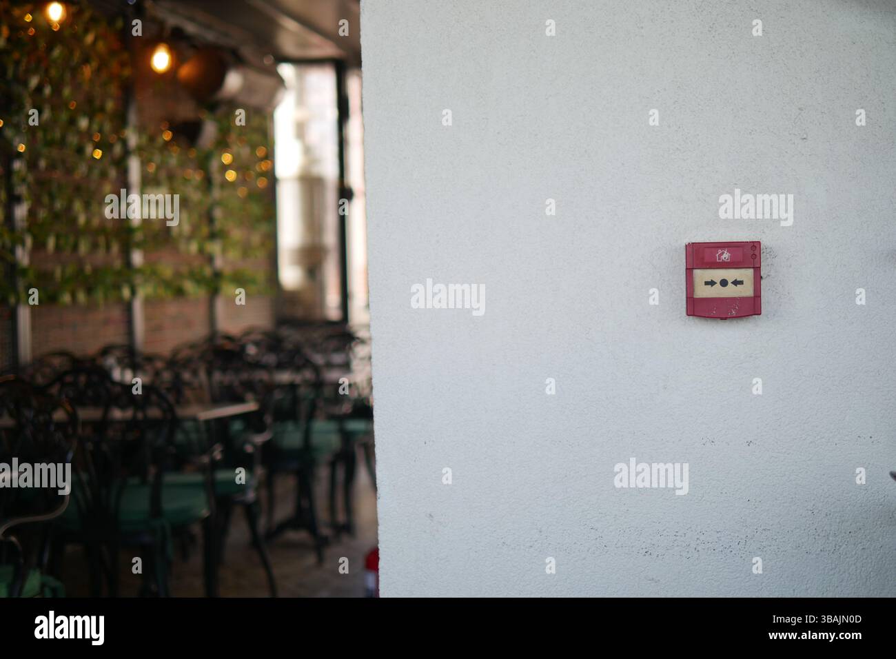Vintage fire alarm on a wall in a bustling restaurant setting Stock ...