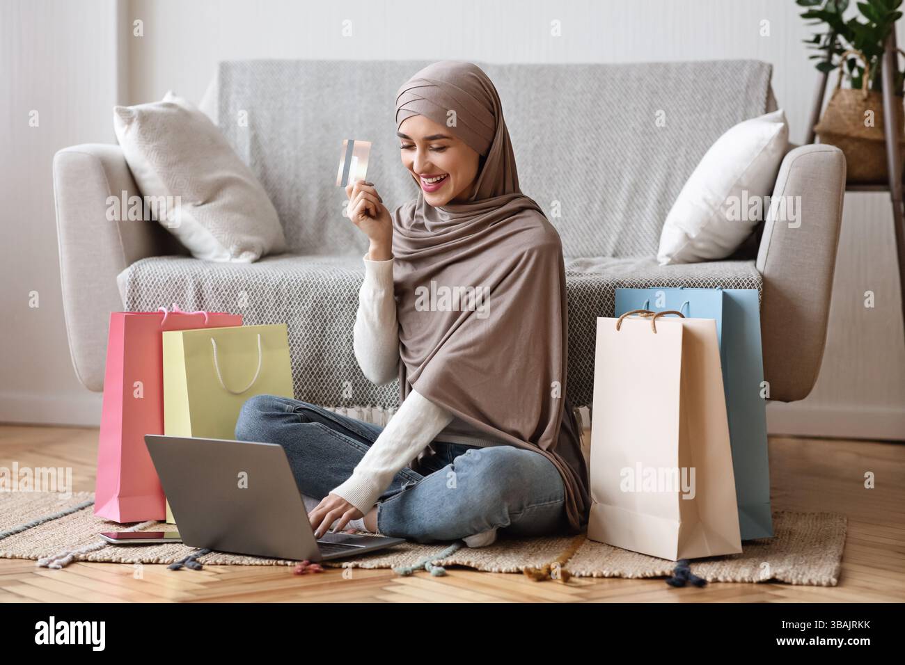 Online Shopping Concept. Young arab woman in hijab typing credit card ...