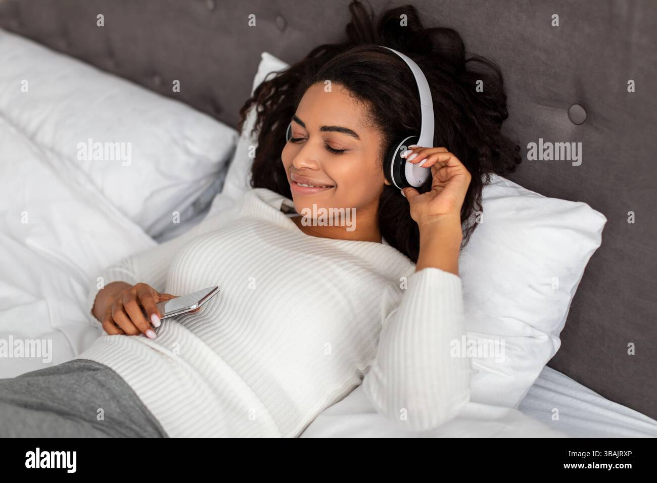 Enjoying Favorite Playlist. Portrait of smiling black lady listening to ...