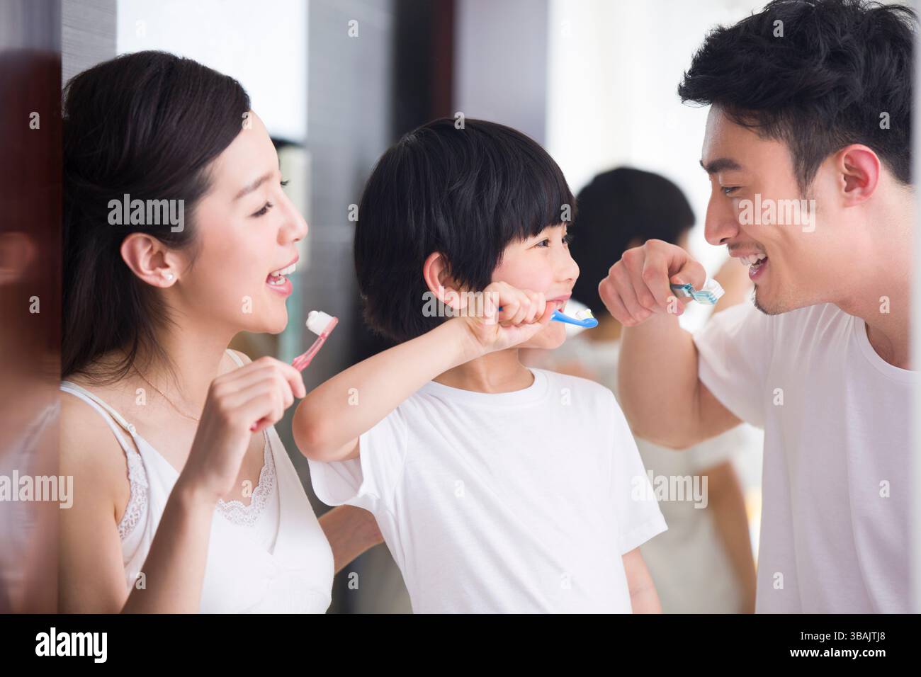 Happy Chinese family brushing teeth Stock Photo - Alamy