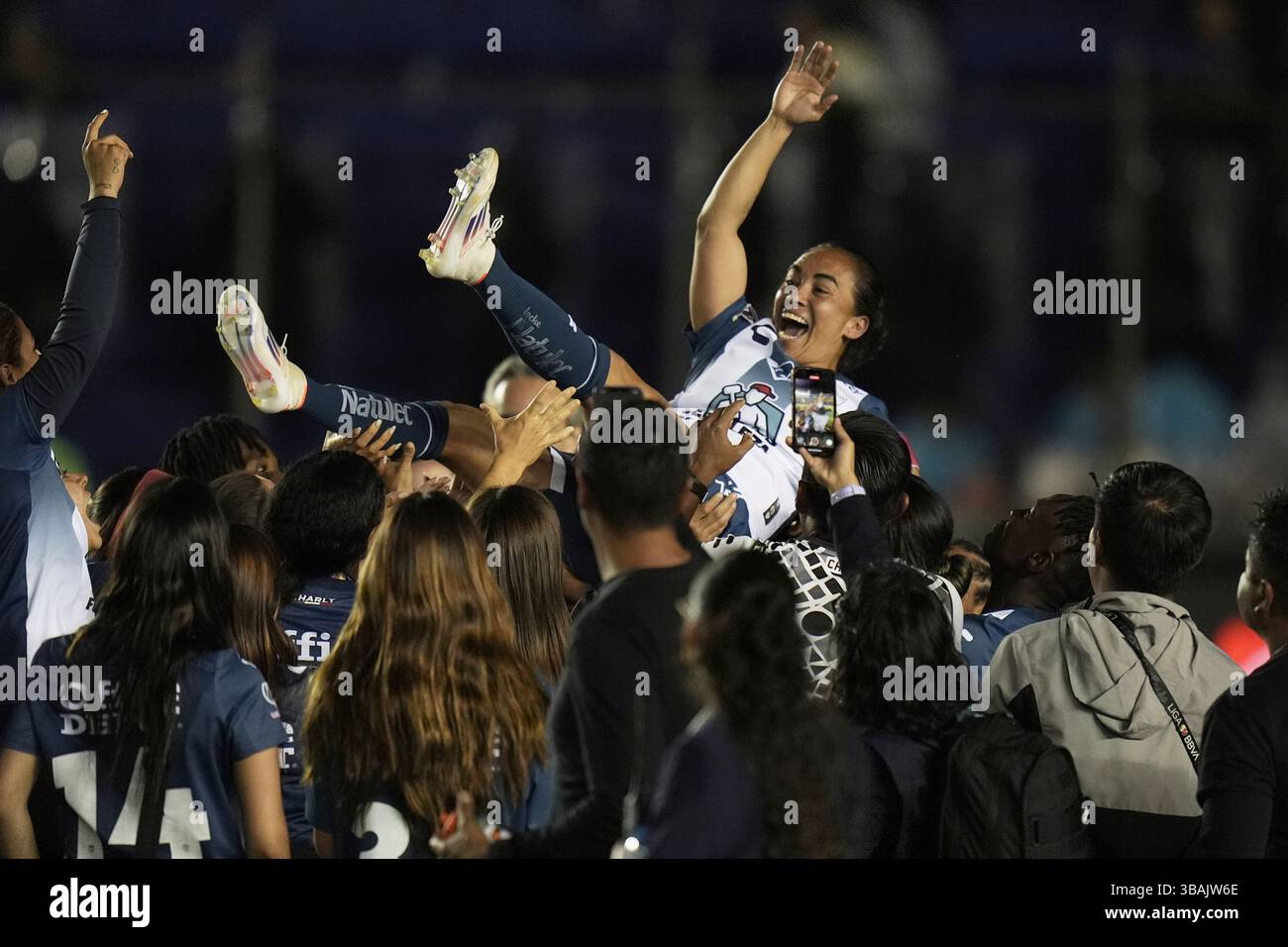 Pachuca players hold up captain Monica Ocampo after winning the Mexican ...