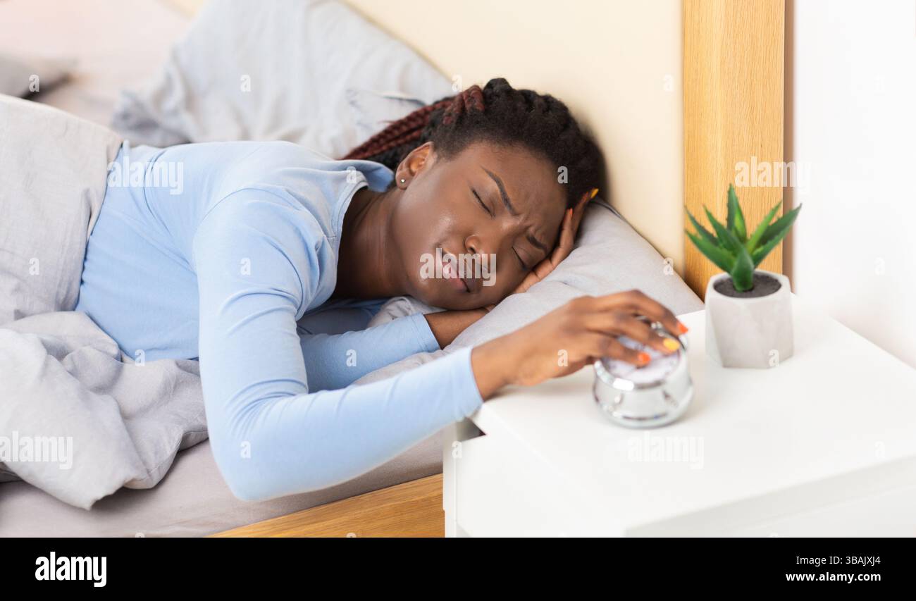 Afro Lady Turning Off The Alarm-Clock Having A Hard Time Waking Up In ...