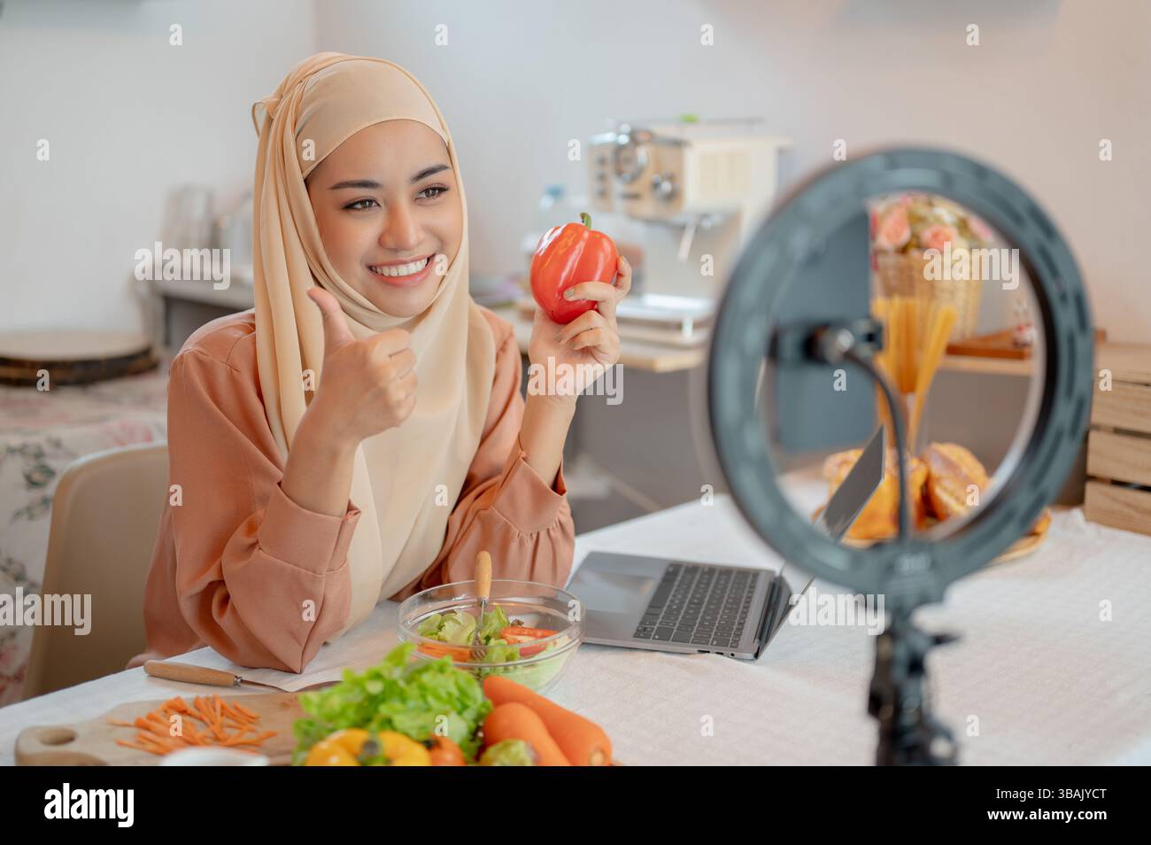 A beautiful Asian Muslim female food blogger or content creator is live ...