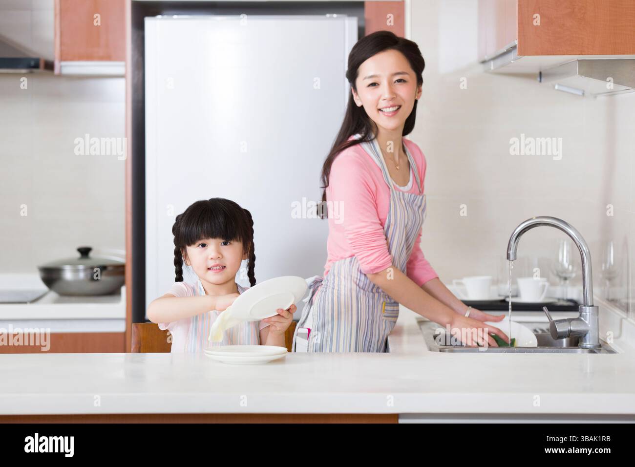 Chinese mother and daughter washing dishes Stock Photo - Alamy