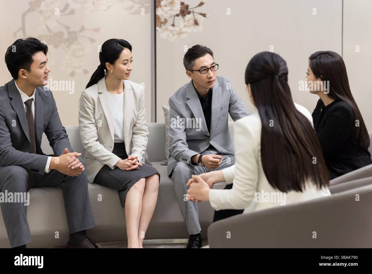 Confident Chinese business people talking in meeting room Stock Photo ...