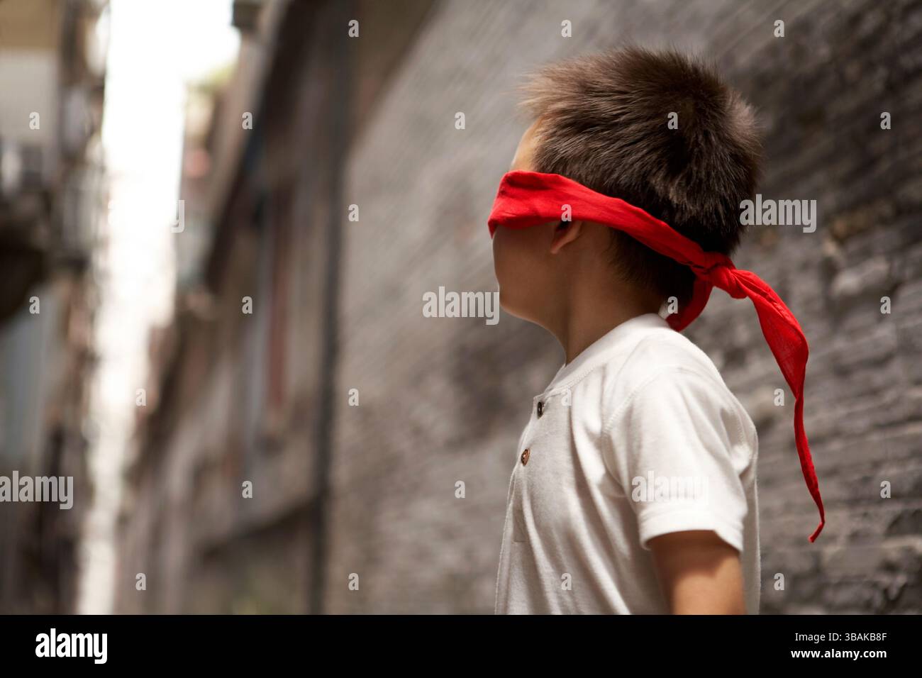 Chinese boy playing hide and seek Stock Photo - Alamy