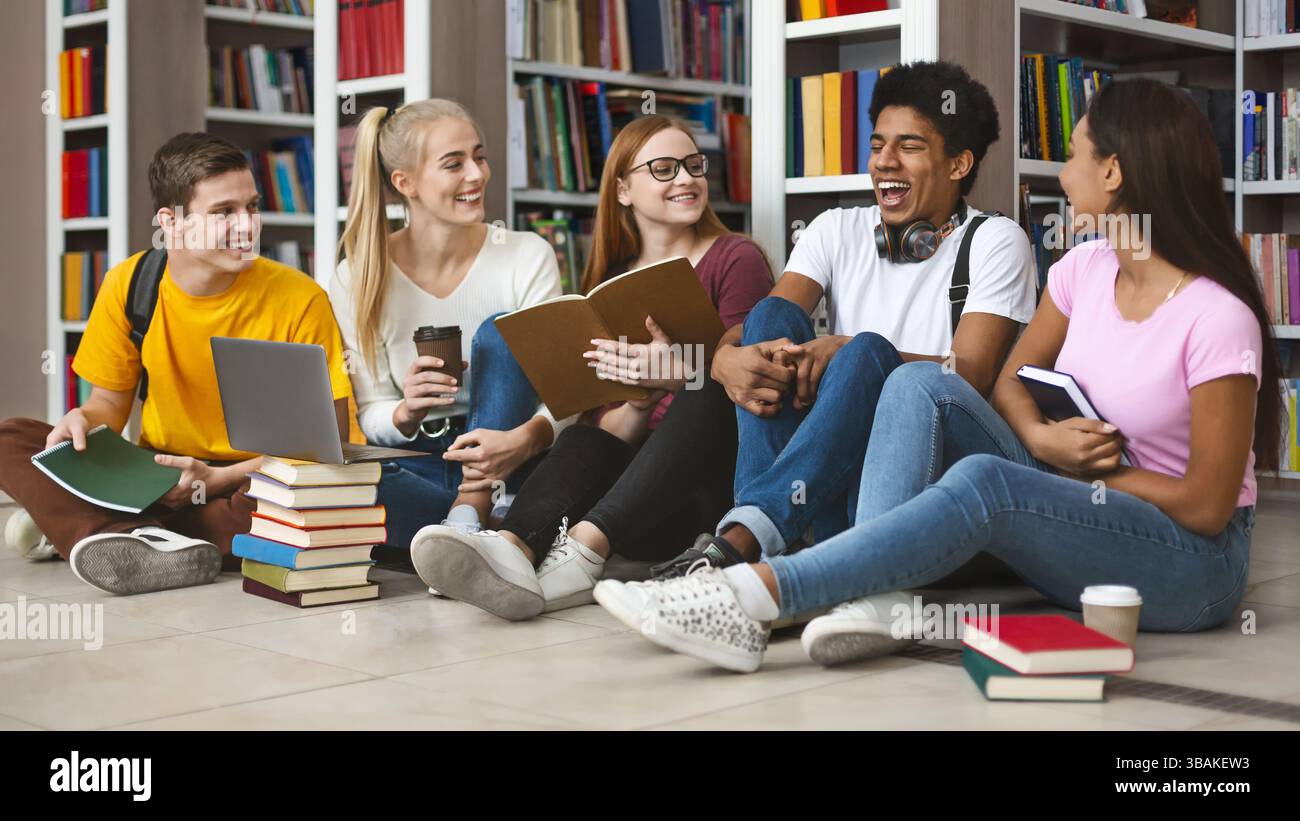 Time for break. Group of international teenage friends laughing while ...