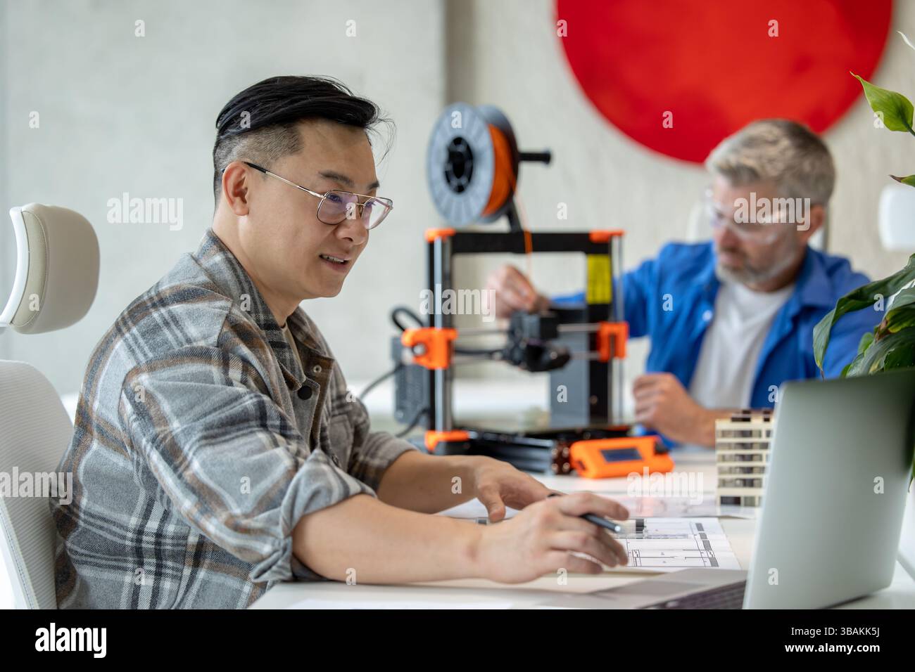 Colleagues architects making house model using 3D printer, FDM ...